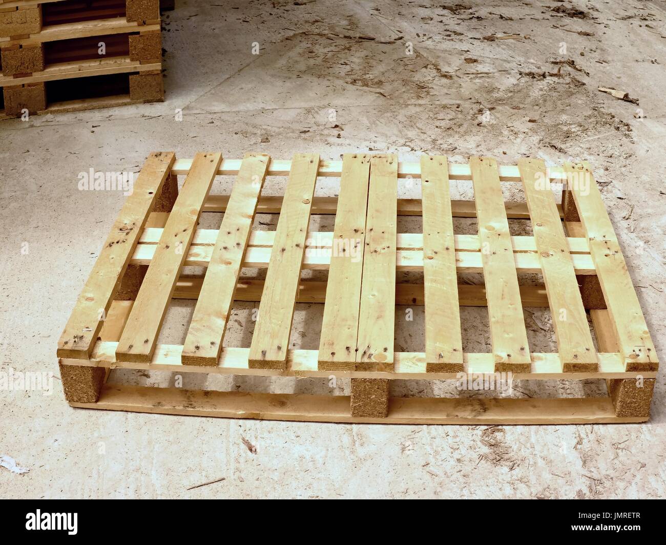 Wooden pallet on worn out concrete ground. Empty pallet ready for ...