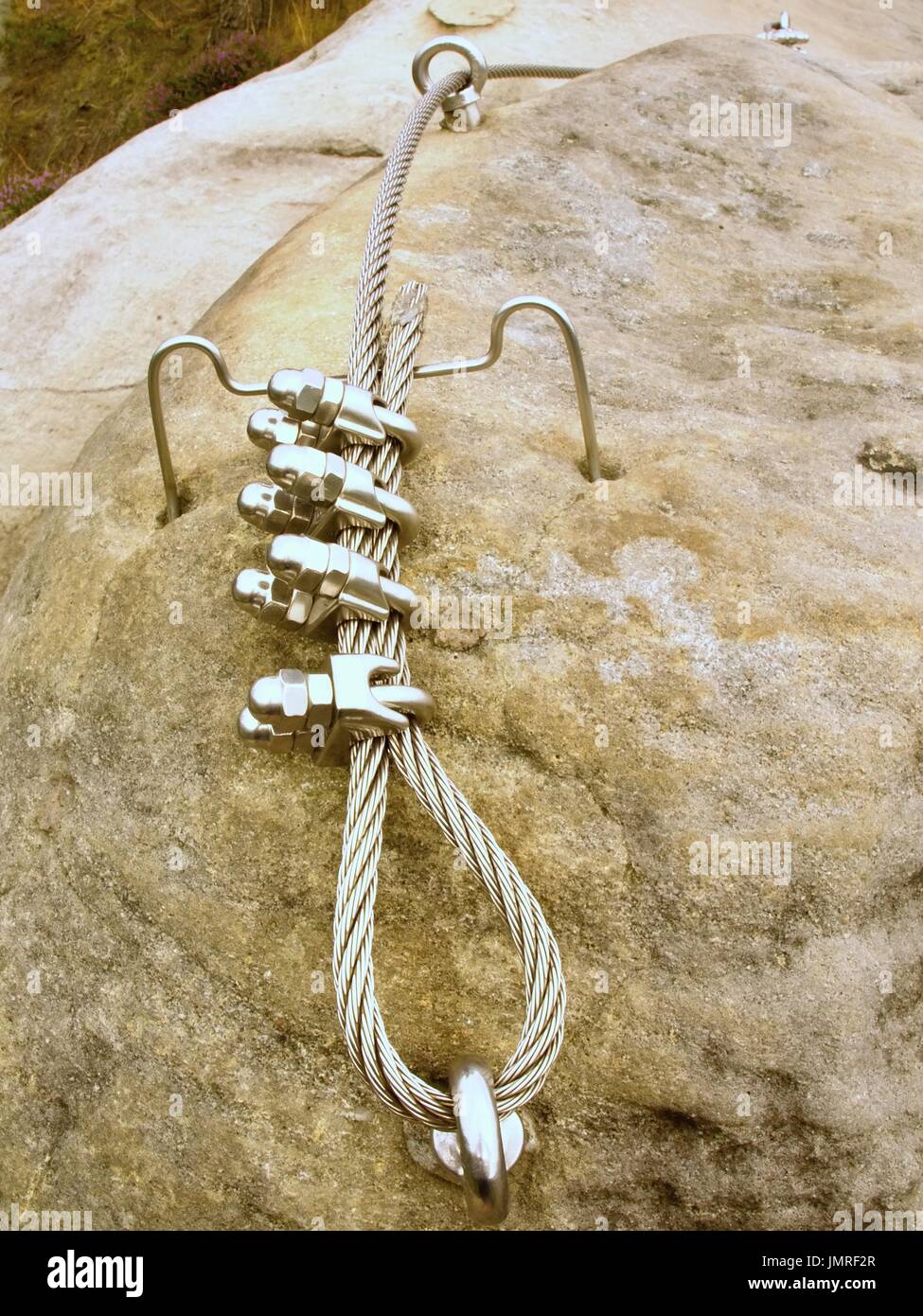 Iron twisted rope fixed in block by screws snap hooks. Detail of rope ...
