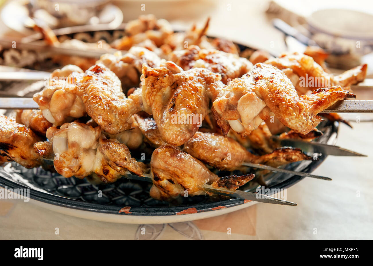 Rosy, fresh roasted on an open fire chicken wings for a family holiday ...