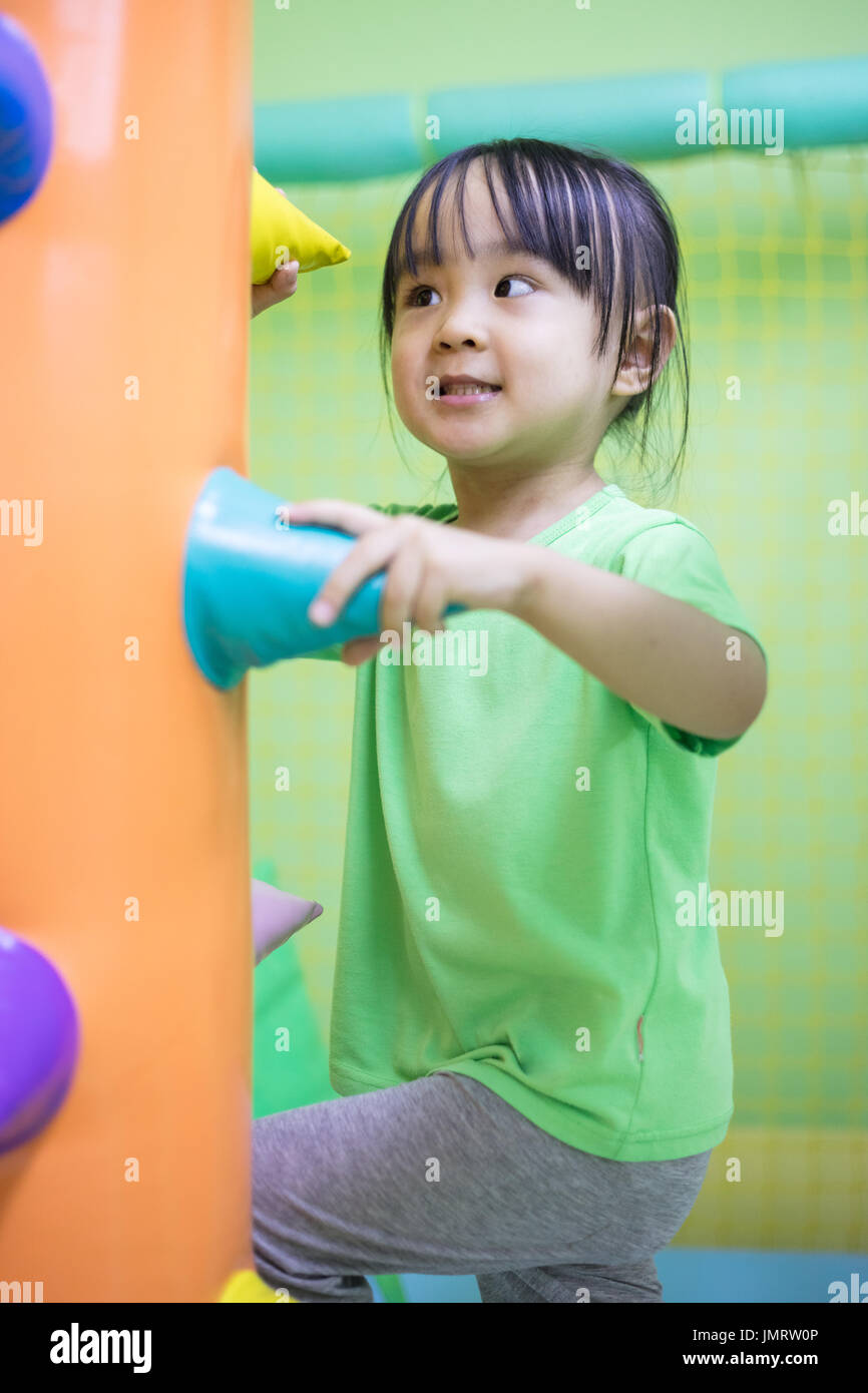 Happy Asian Chinese little girl playing at indoor playground Stock ...