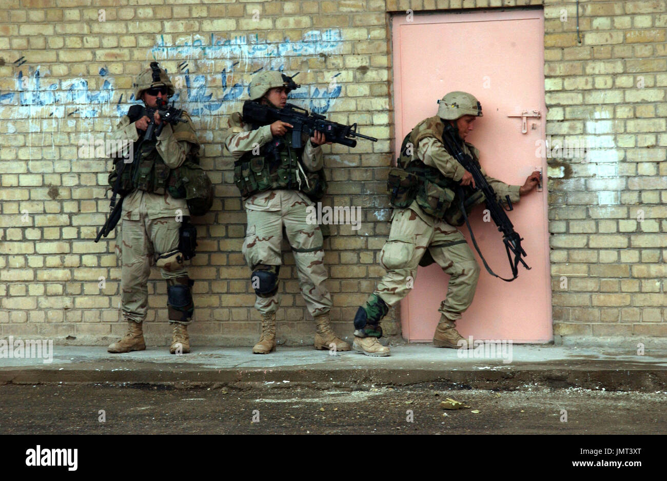 United States Army soldiers are poised to enter a building in Fallujah ...