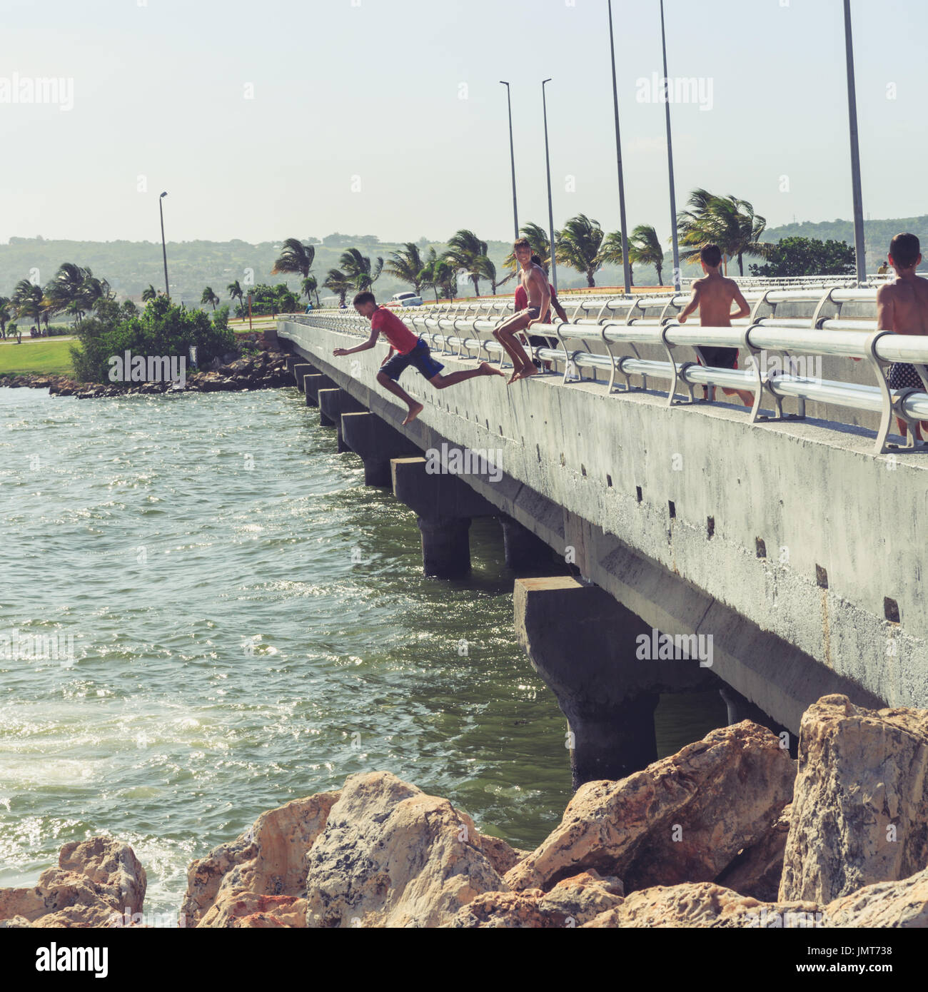 Children jumping into the sea hi-res stock photography and images - Alamy