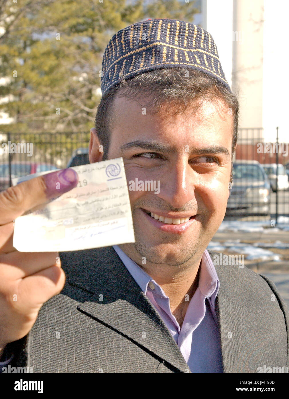 Shwan Hussein, a Kurd from Northern Iraq, proudly displays his voter ...
