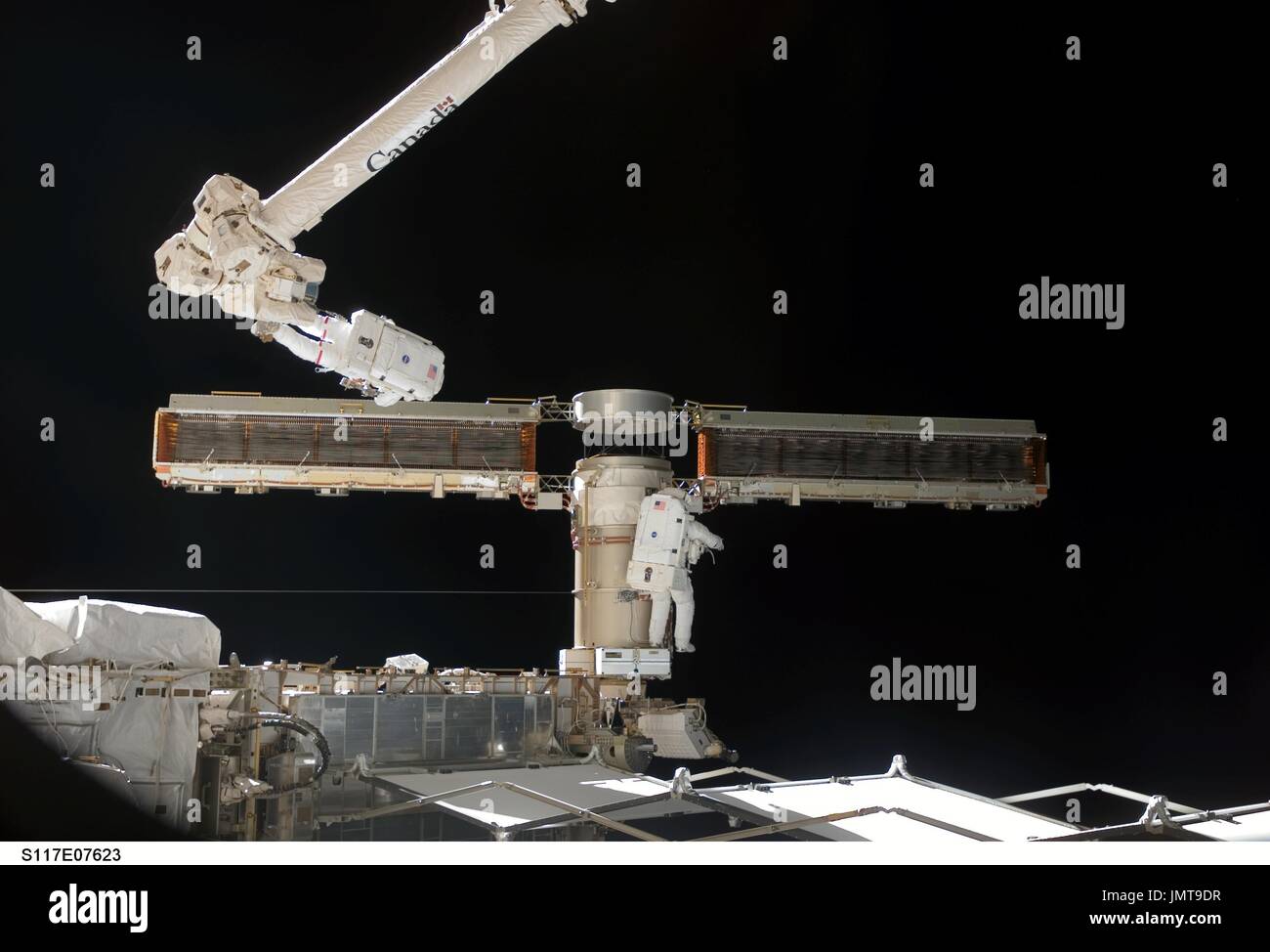 In Earth Orbit - June 15, 2007 -- Astronauts Jim Reilly (on robot arm ...