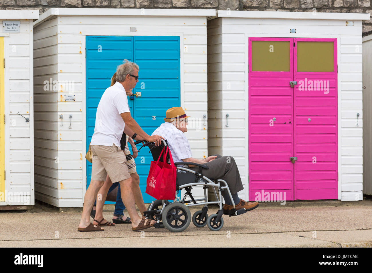 Old man pushing wheelchair hi-res stock photography and images - Alamy
