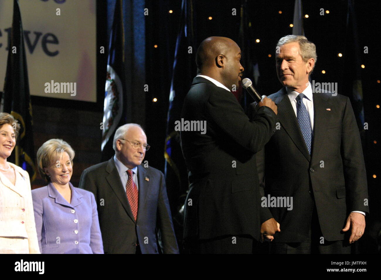 President George W. Bush holds hands with gospel singer Bebe Winan as ...