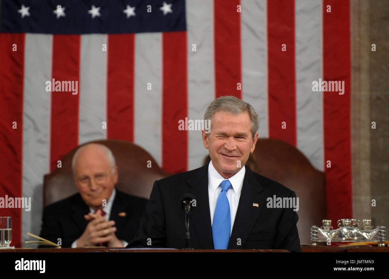 US President George W. Bush winks to a member of the audience before he ...