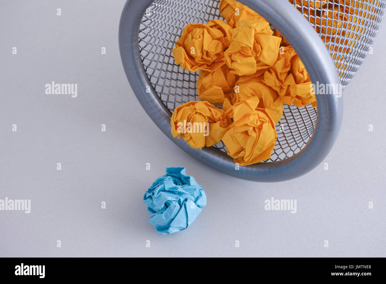 Crumpled paper balls rolling out of a trash can. Close up Stock Photo ...