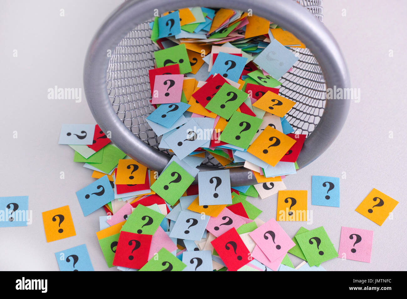 Question marks falling out of trash can. Close up Stock Photo - Alamy