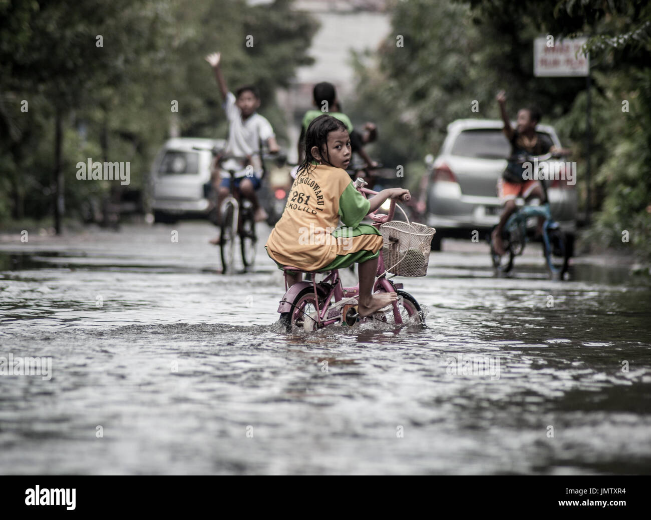 Kids playing in flood hi-res stock photography and images - Alamy