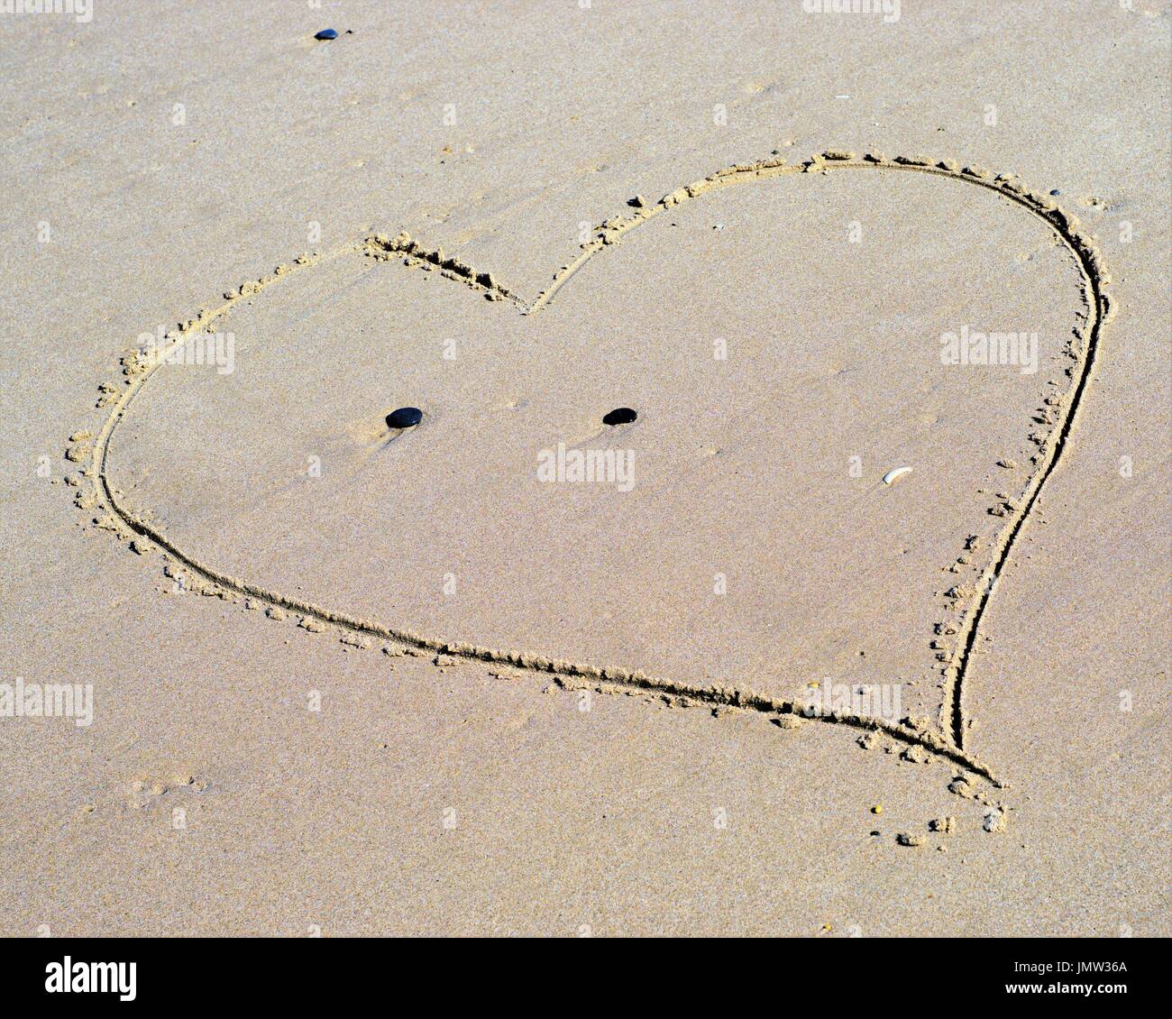 Heart shape on sand Stock Photo - Alamy