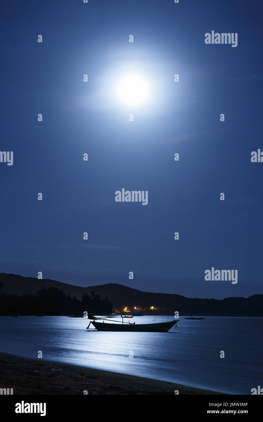 Little boat under moonlight Stock Photo - Alamy