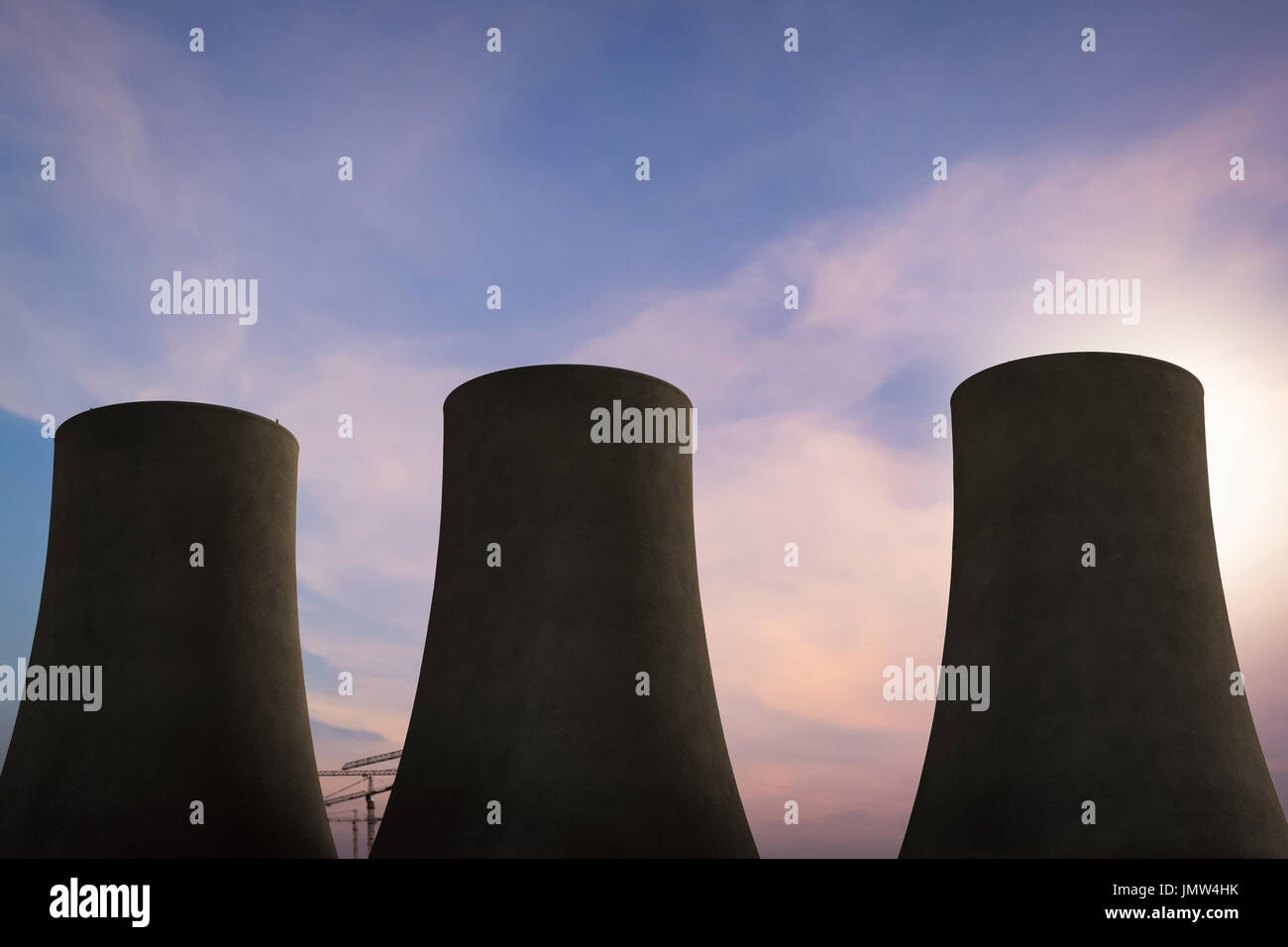 nuclear power plant on sunset sky background Stock Photo - Alamy