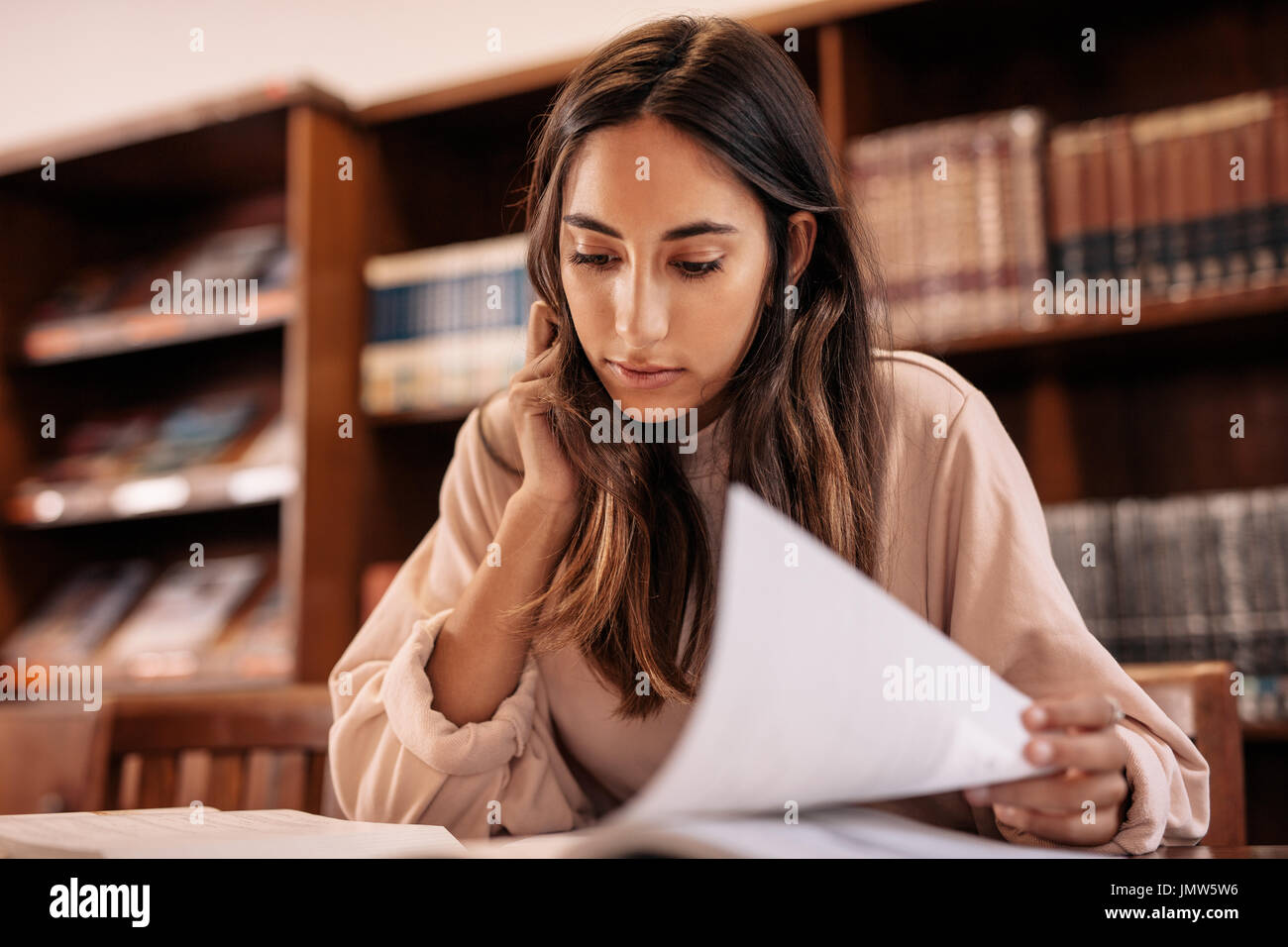 University student researching in library hi-res stock photography and ...