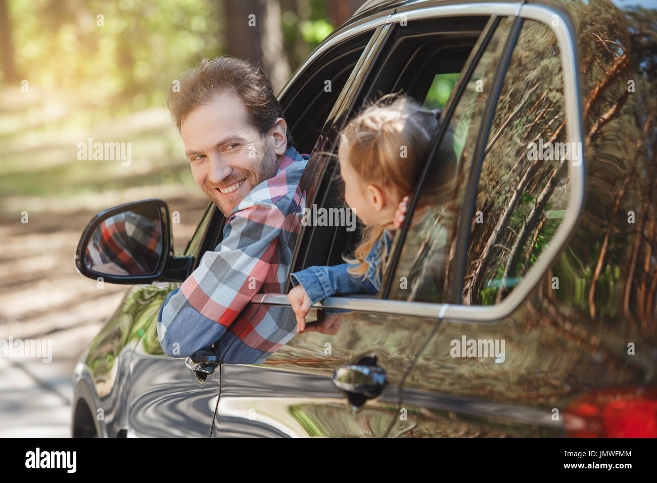 Travel by car family ride together father and daughter lean out of the ...