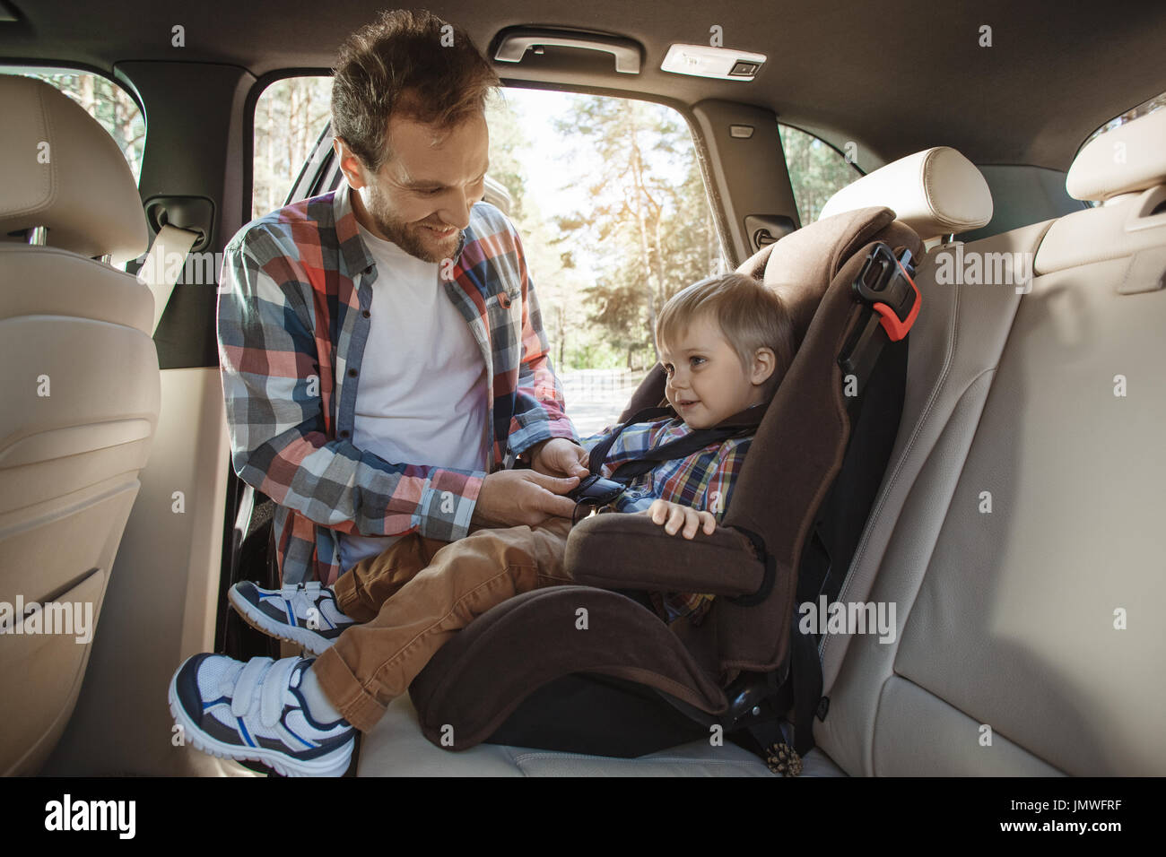 Travel by car family ride together child safety Stock Photo - Alamy