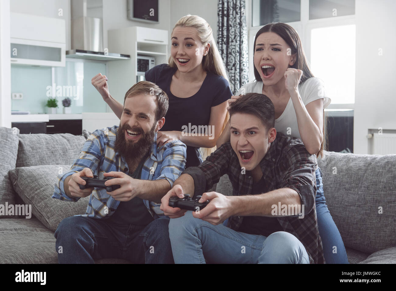 Friends having party together indoors playing video games Stock Photo ...