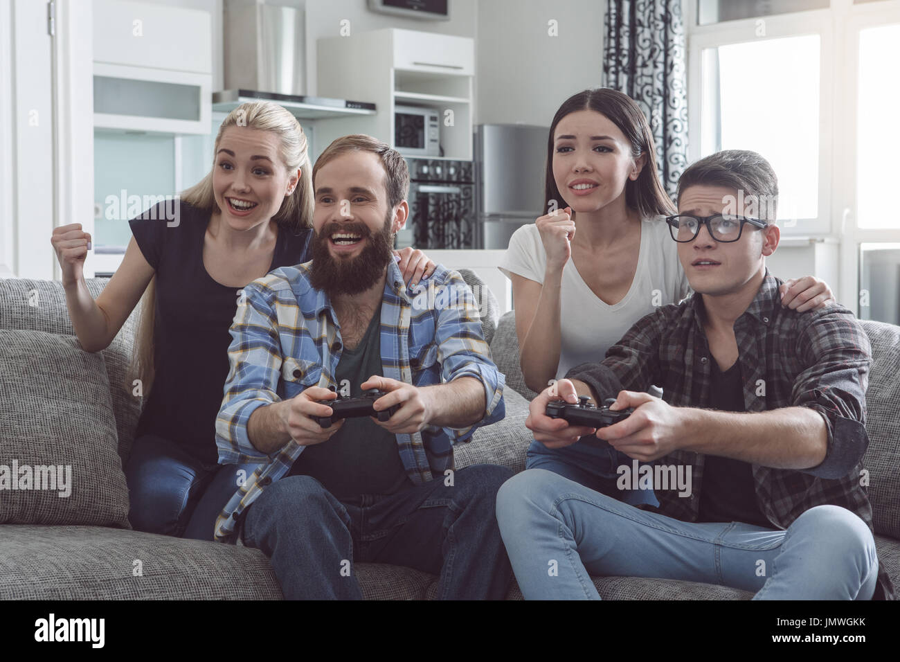Friends having party together indoors playing video games Stock Photo ...