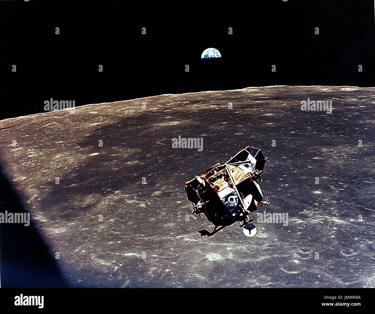 In Lunar Orbit - (FILE) -- With a half-Earth in the background, the ...