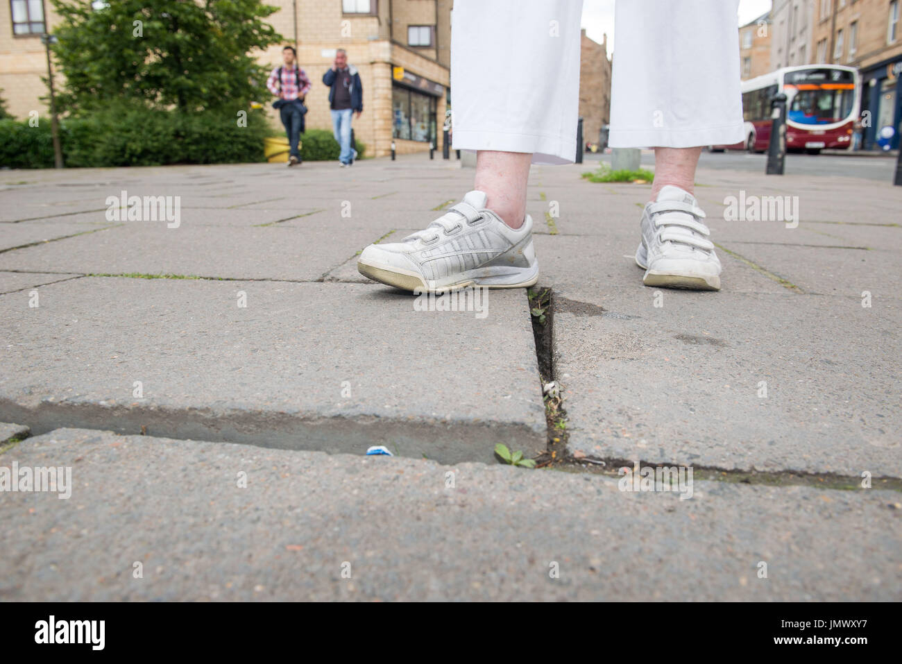 Picture: broken pavement with loose slabs and cracked cement, Council ...