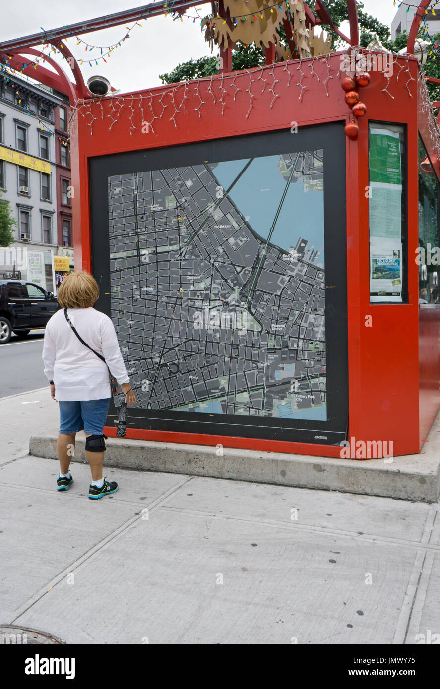 A tourist checking out a map of downtown Manhattan at the Chinatown ...