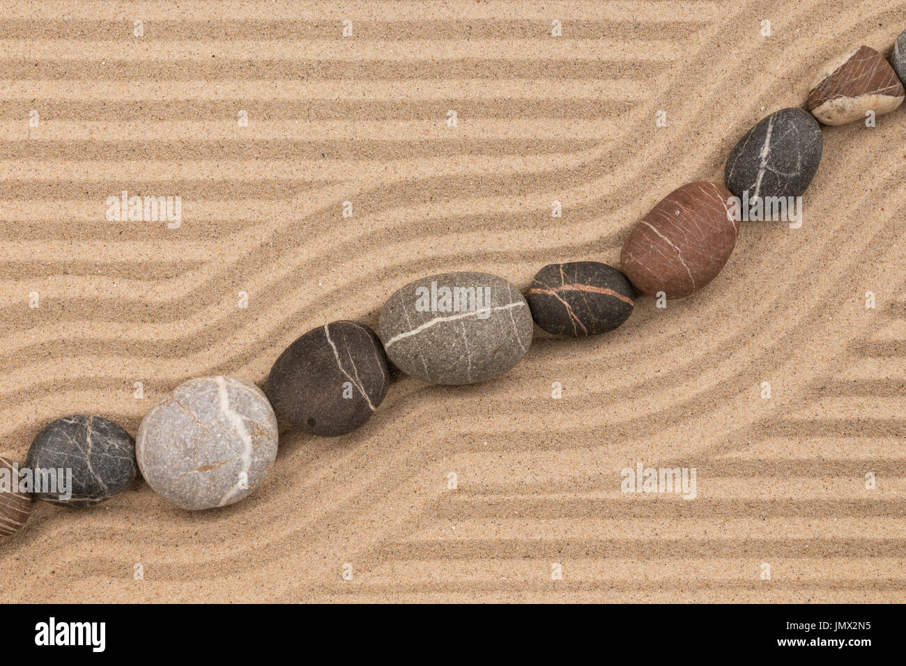 Still life. Striped stones lying on striped sand. View from above Stock ...
