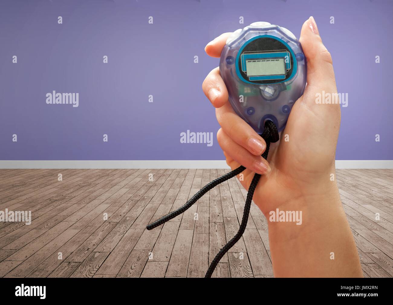 Digital composite of Hands holding stopwatch timer in purple room Stock ...