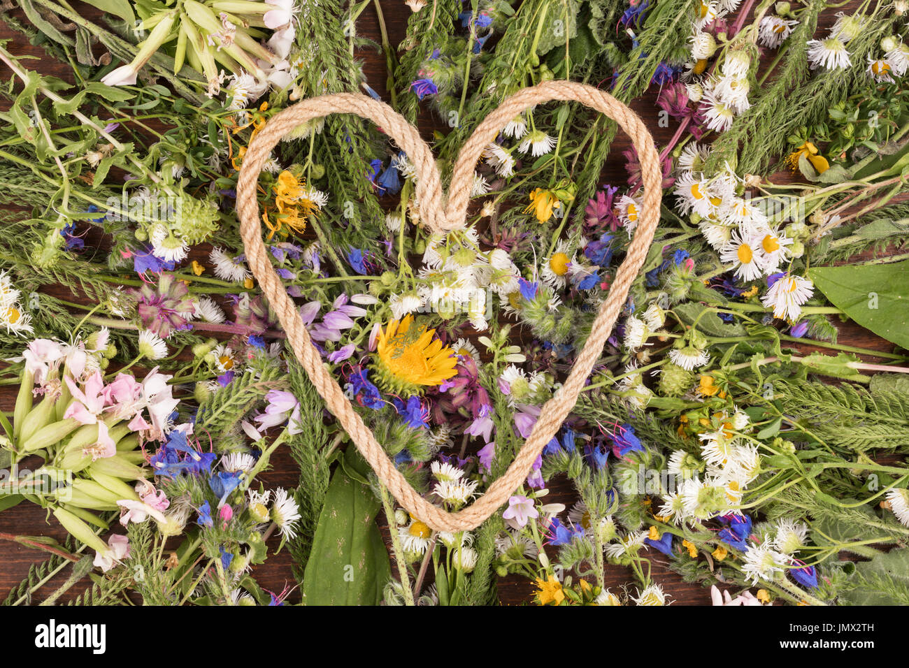Beautiful frame in the shape of a heart made out of rope lying on ...