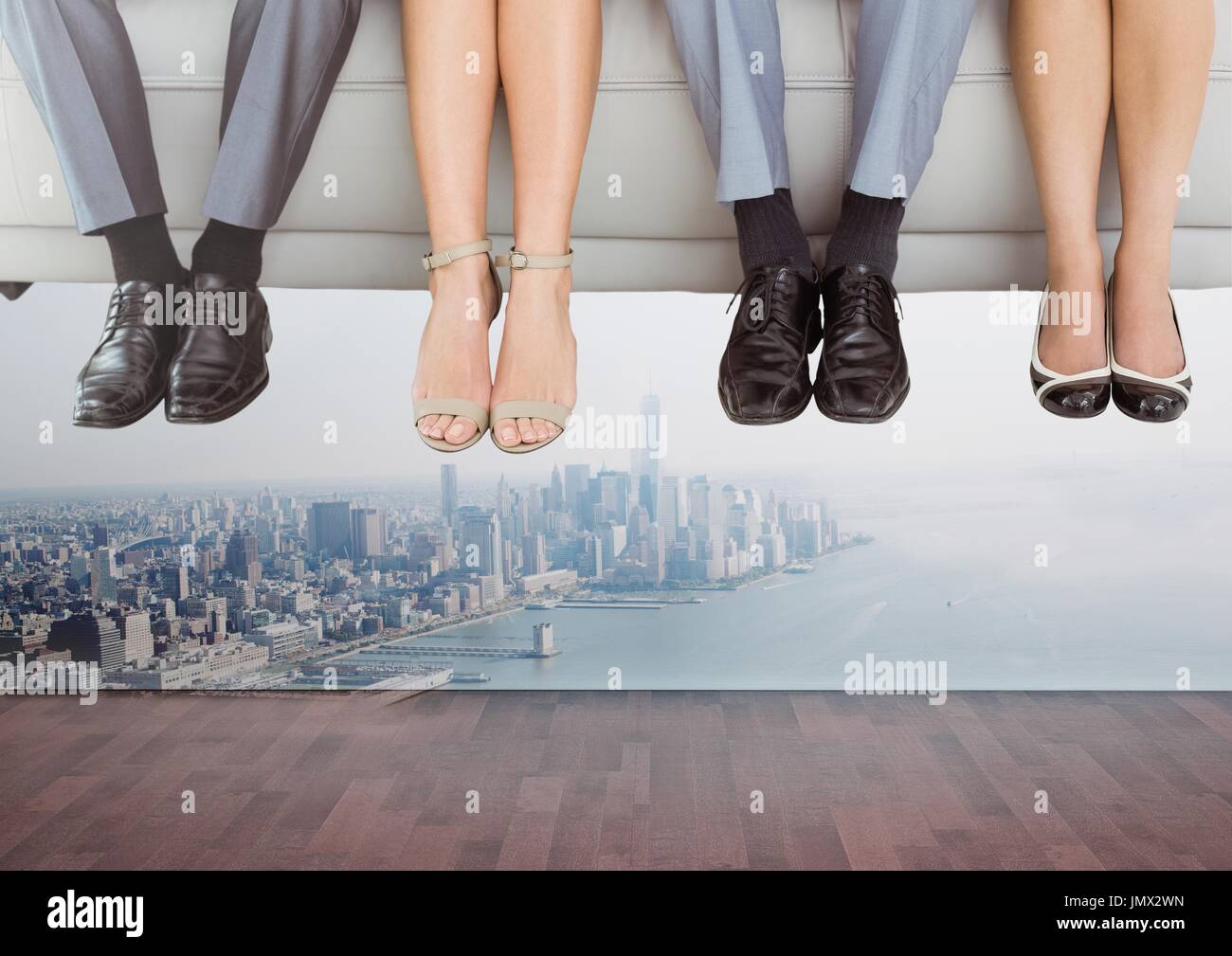 Digital composite of People's feet hanging off floating couch over city ...