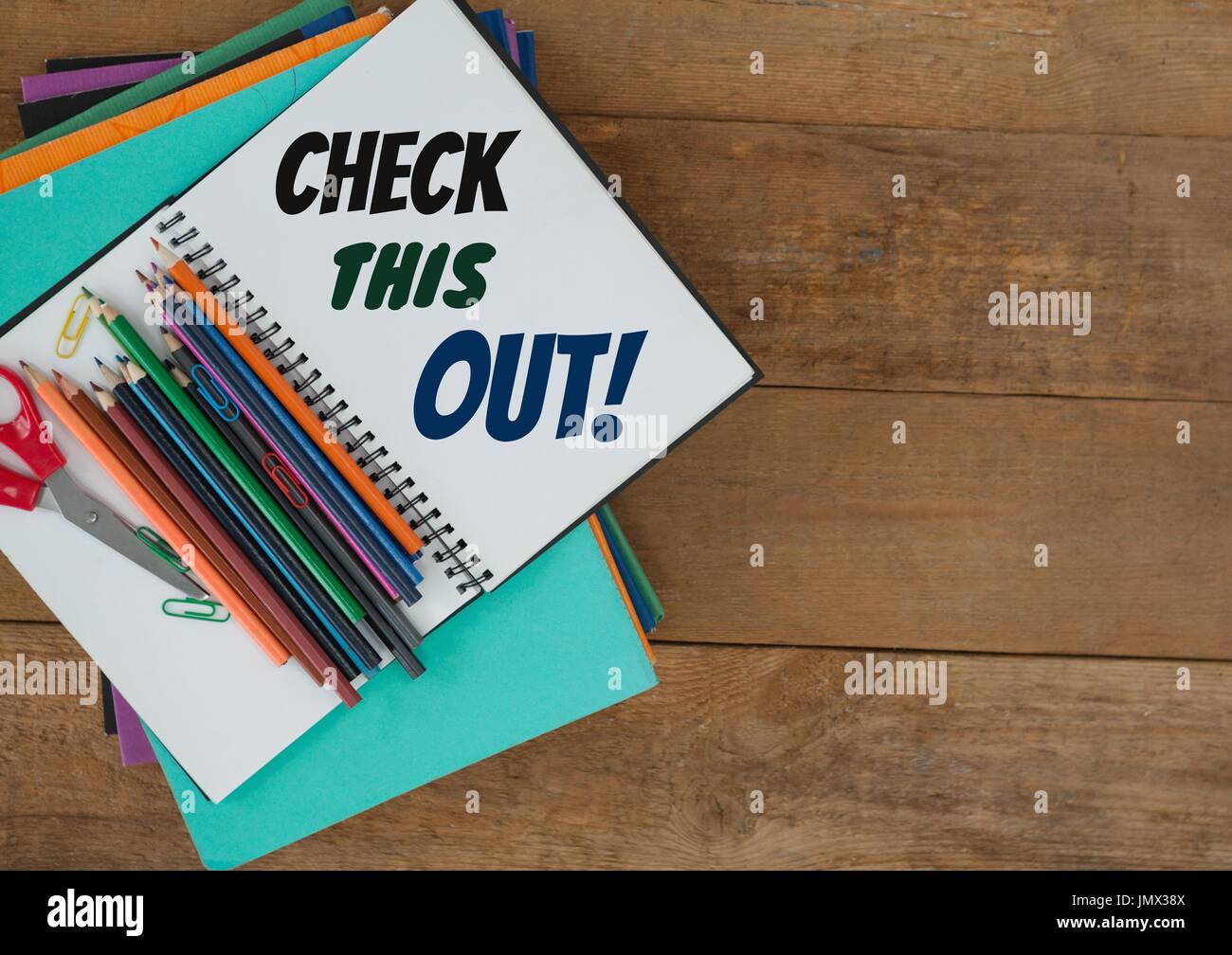 Digital composite of Check this out text written on page with wood ...