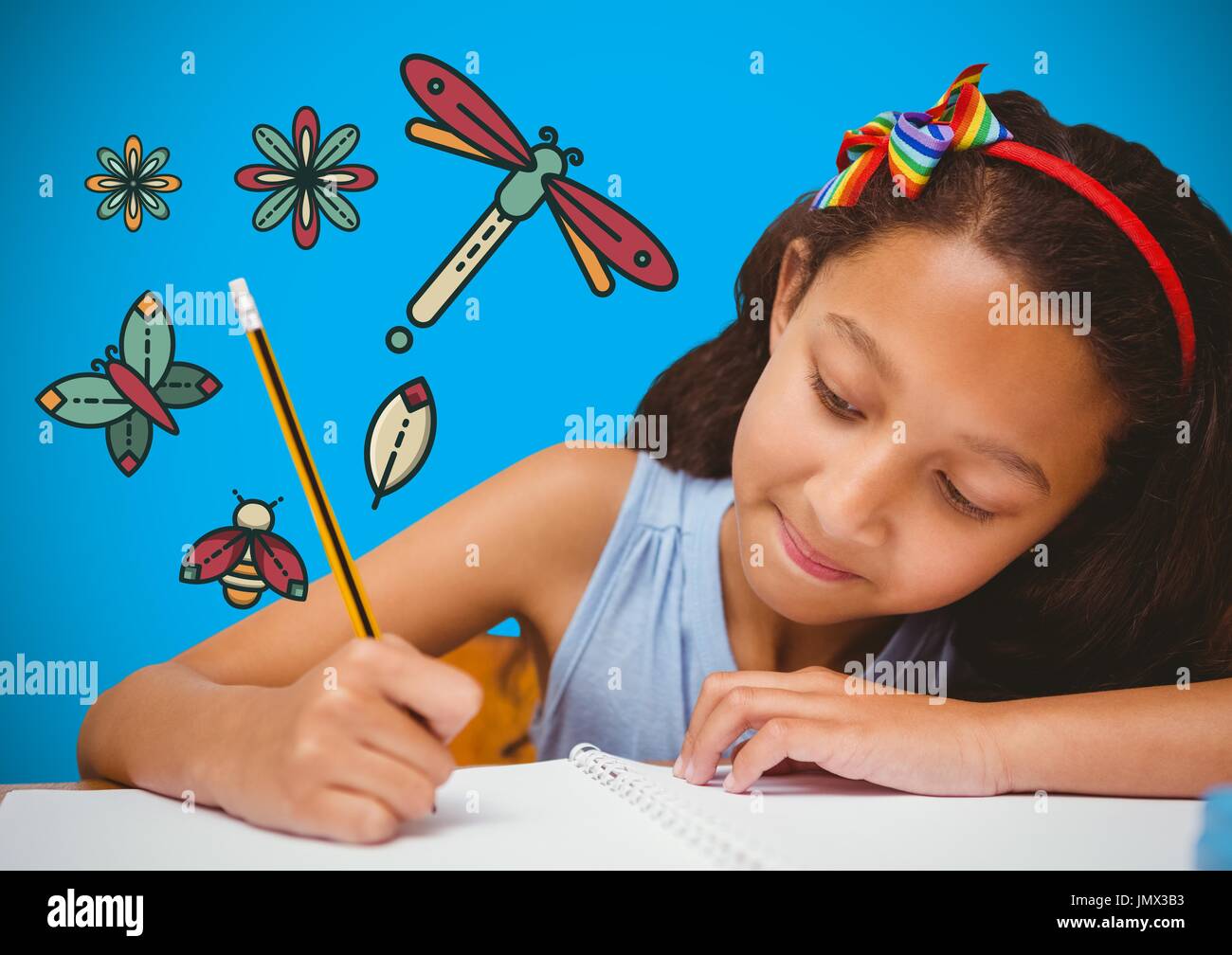Digital composite of Girl writing in front of blue blank background ...