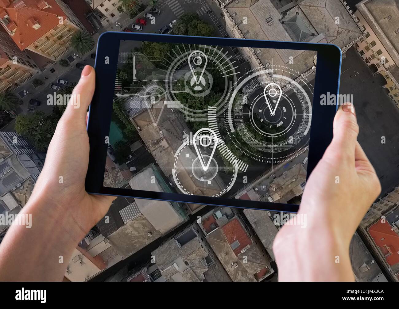 Digital composite of Holding tablet and City aerial view with marker ...