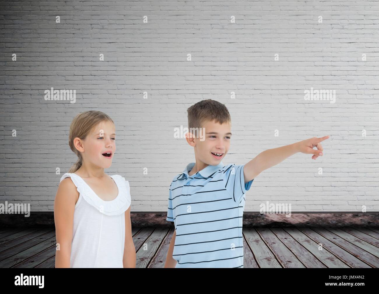 Digital composite of kids pointing surprised with blank room background ...