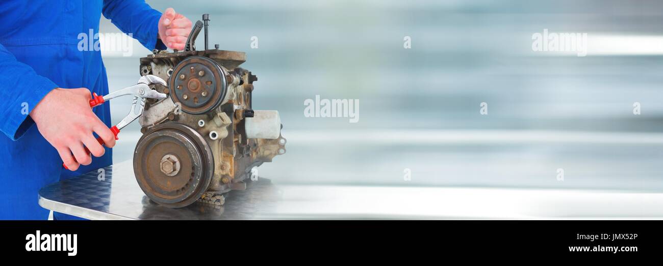 Digital composite of Mechanic repairing a motor Stock Photo - Alamy