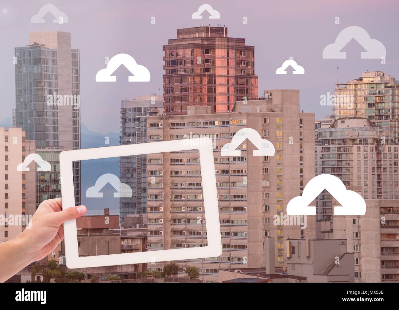 Digital composite of Holding tablet and Upload icons over city Stock ...