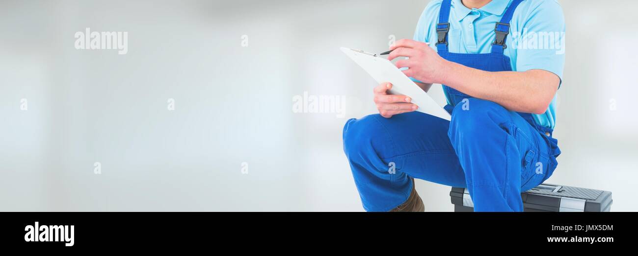 Digital composite of Plumber man sitting and writing against white ...