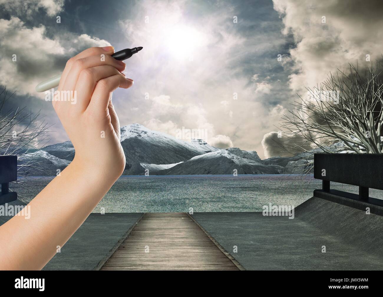 Digital composite of Hand writing in sky of mystical dramatic landscape ...