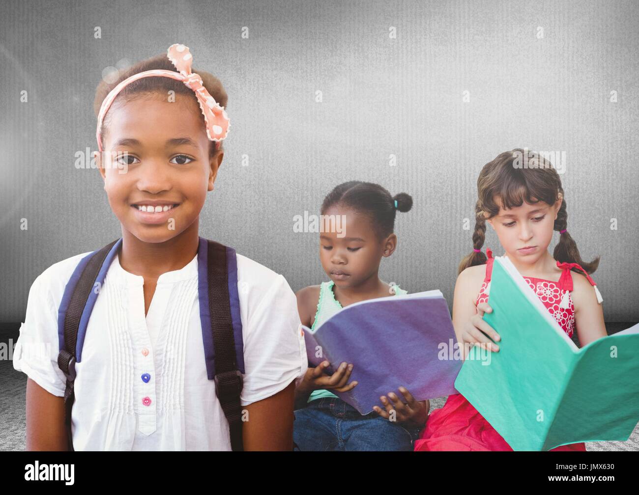 Digital composite of Kids reading books in front of grey room Stock ...