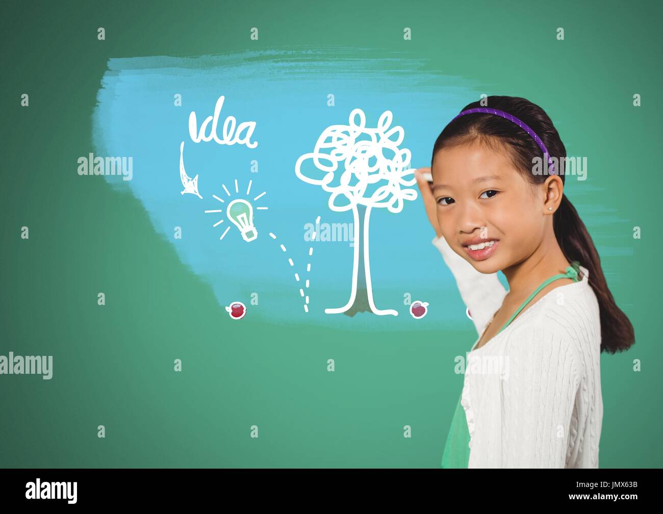 Digital composite of Girl writing in front of green blank background ...