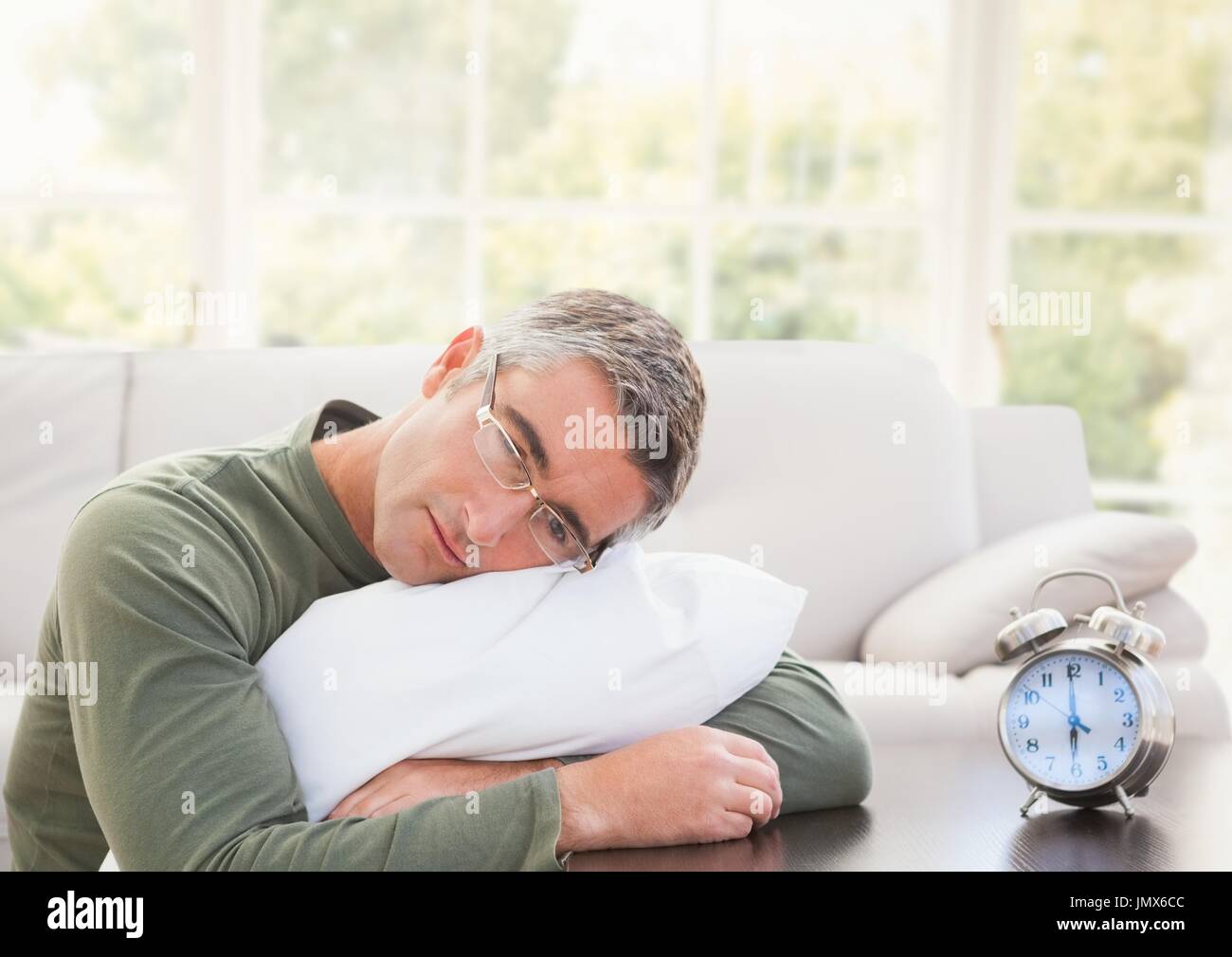 Digital composite of man tired by clock in front of windows Stock Photo ...