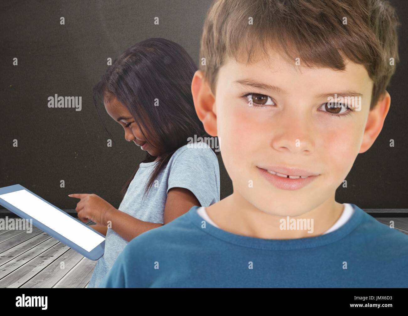 Digital composite of Boy and girl with tablet in front blackboard Stock ...