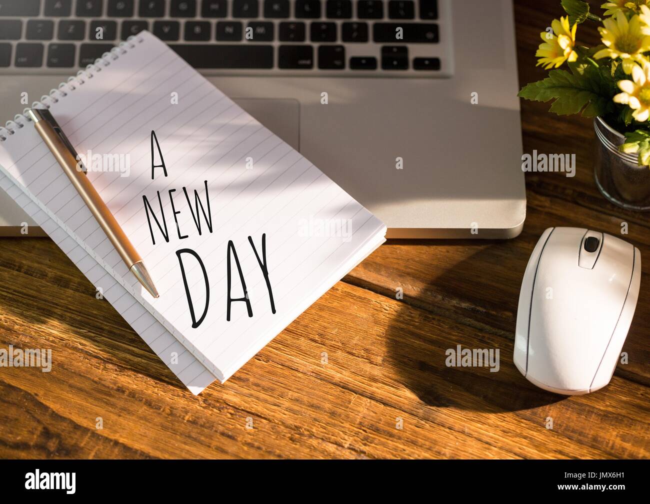 Digital composite of A New Day text written on page with laptop Stock ...