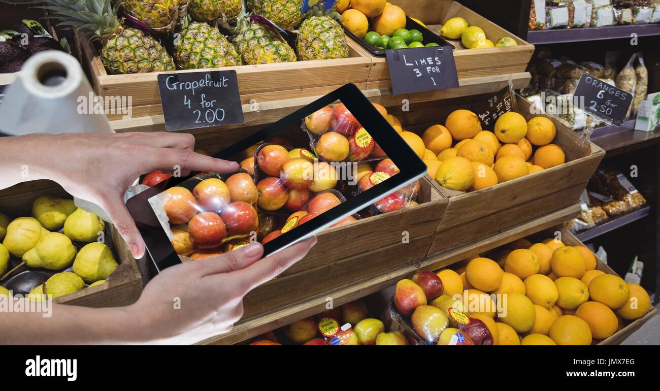 Digital composite of Hands photographing apples through digital tablet ...