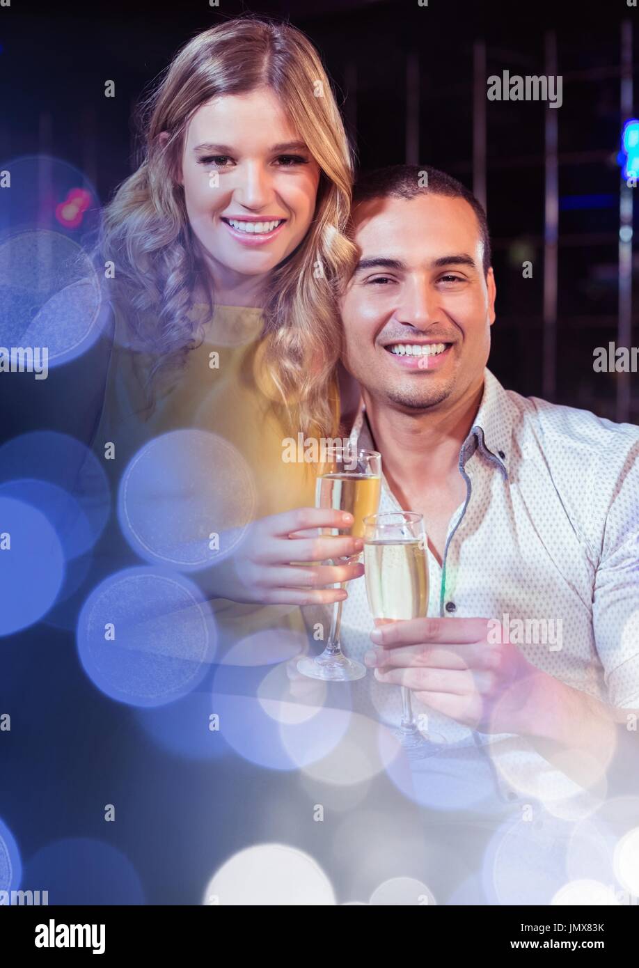 Digital composite of Couple having fun celebration party with sparkling ...