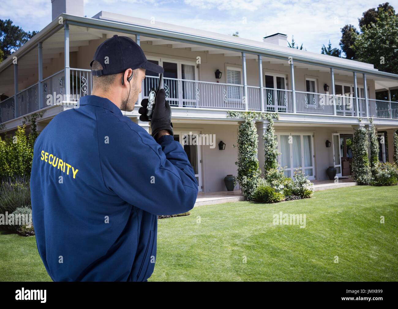 Digital composite of Security guard using radio outside house Stock ...