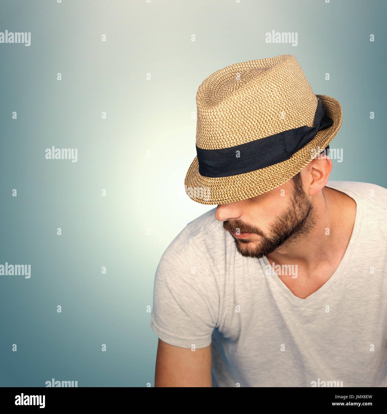 Handsome man wearing hat against grey vignette Stock Photo - Alamy