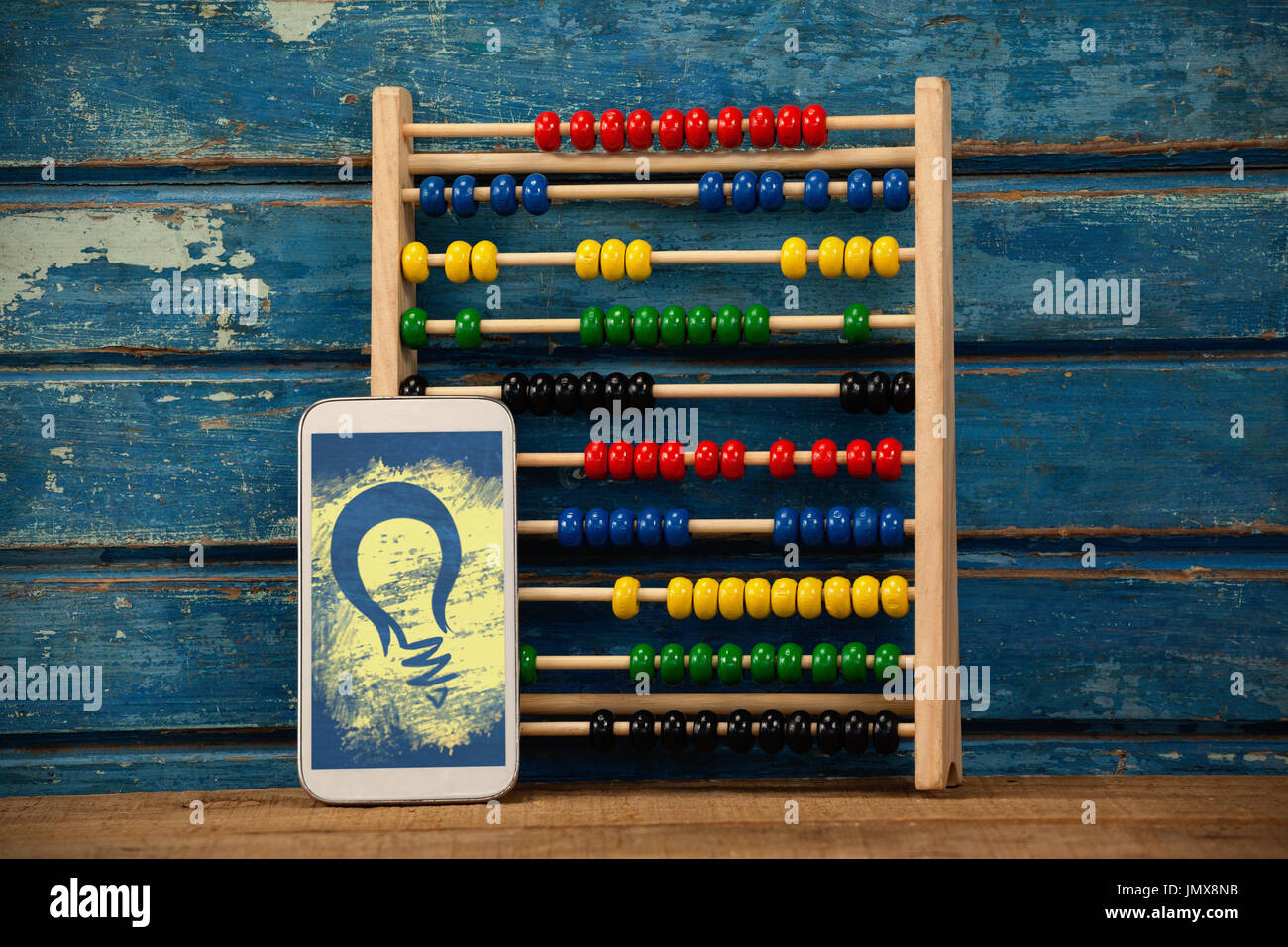 Digital composite image of light bulb on blue spray paint against ...