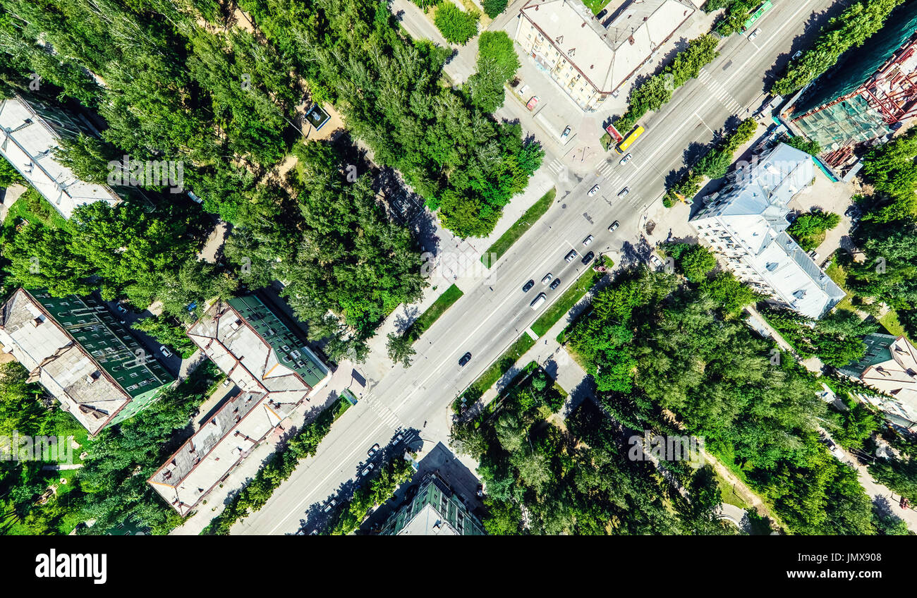Aerial city view with crossroads and roads, houses, buildings, parks ...