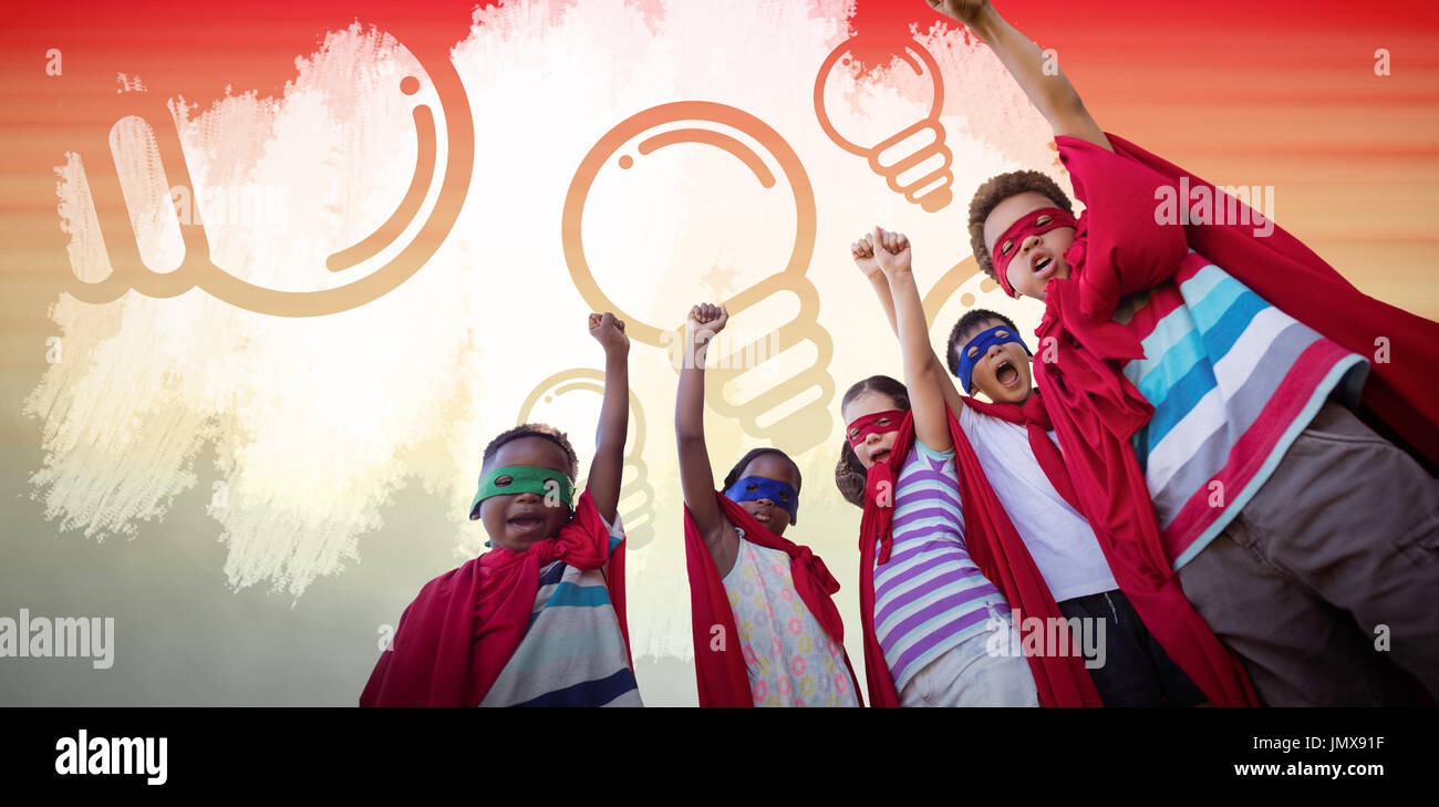 Low angle view of children in superhero costumes against orange and ...