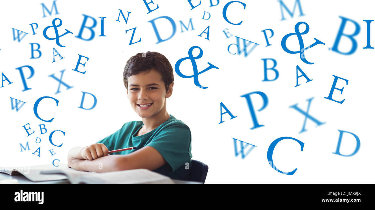 Portrait of boy doing homework against letters Stock Photo - Alamy